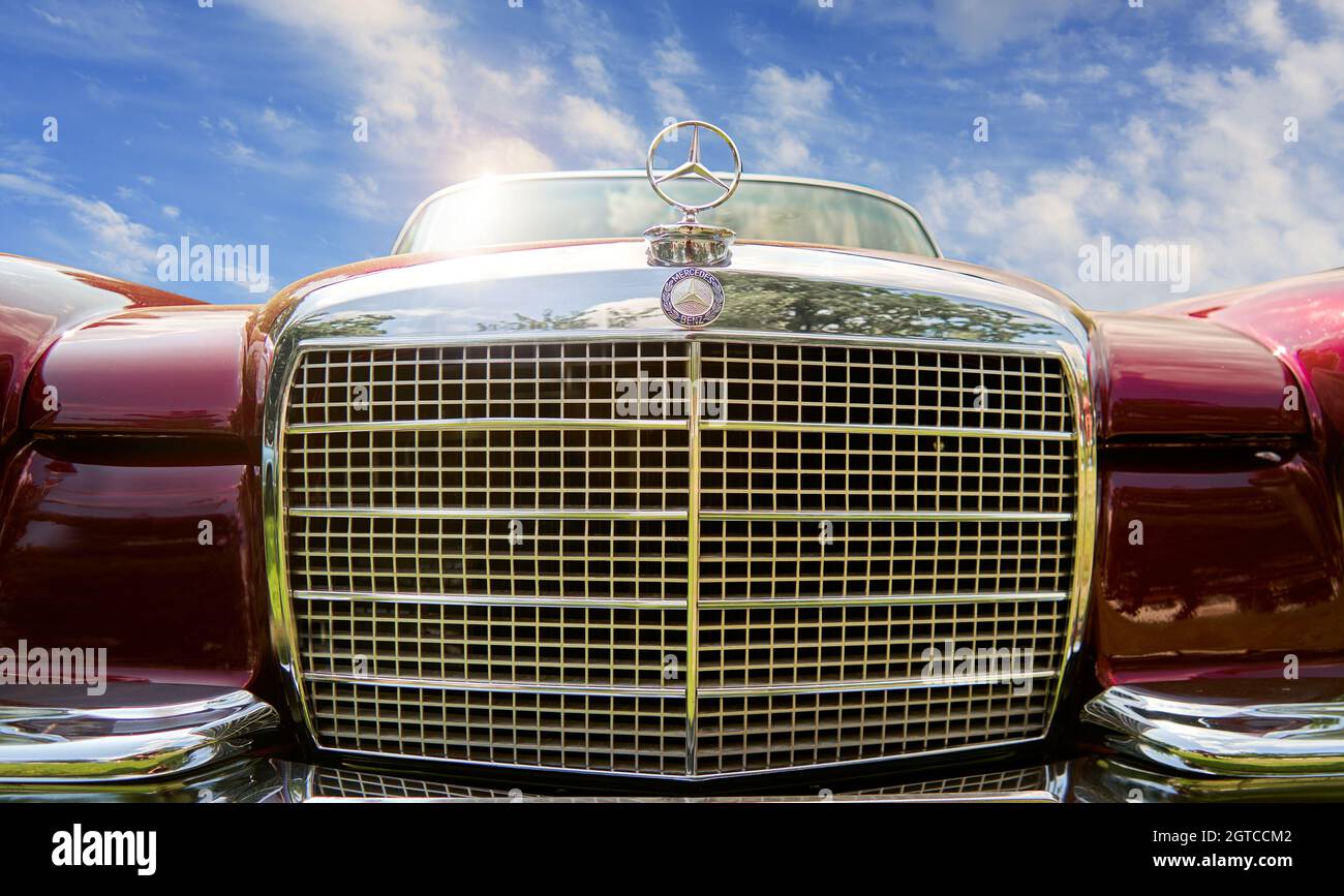Mercedes star and Mercedes coat of arms on the front of a red classic ...