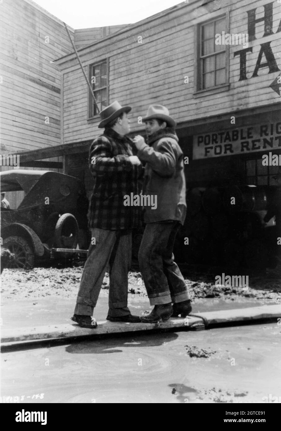 SPENCER TRACY and CLARK GABLE falling into muddy street in BOOM TOWN ...