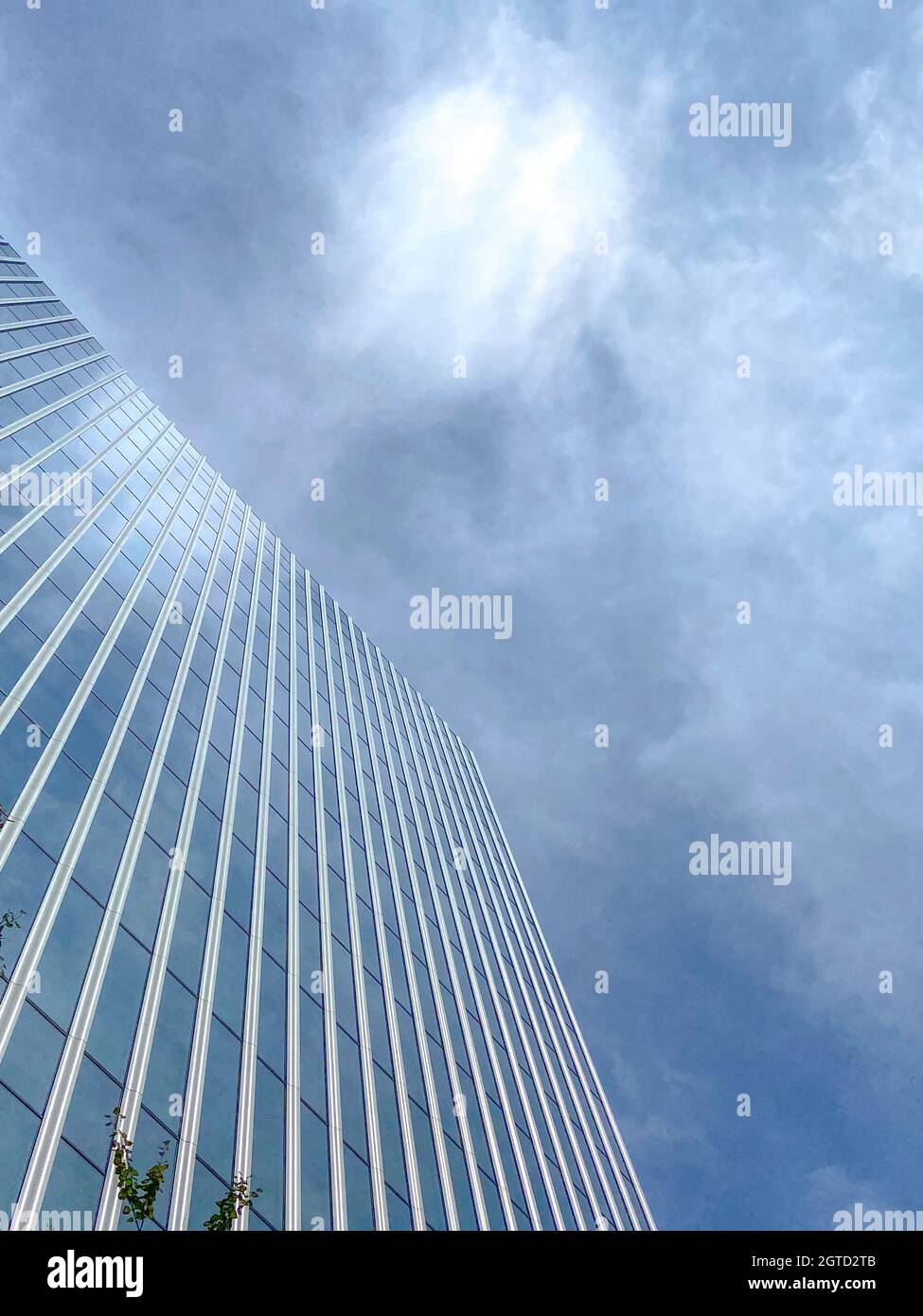 Tall office building in blue sky background Stock Photo - Alamy
