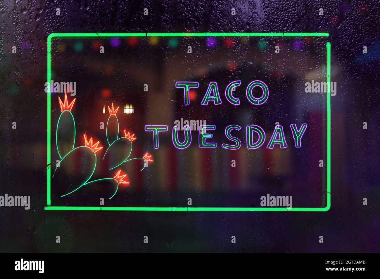 Taco Tuesday Neon Sign in Rainy Window of Mexican Restaurant Stock ...