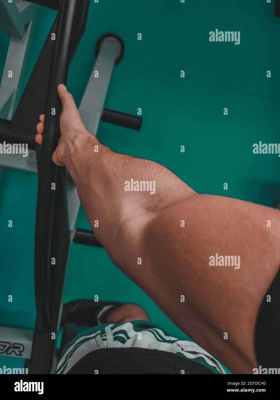Selective of a man's hand holding a bar for stretching Stock Photo - Alamy
