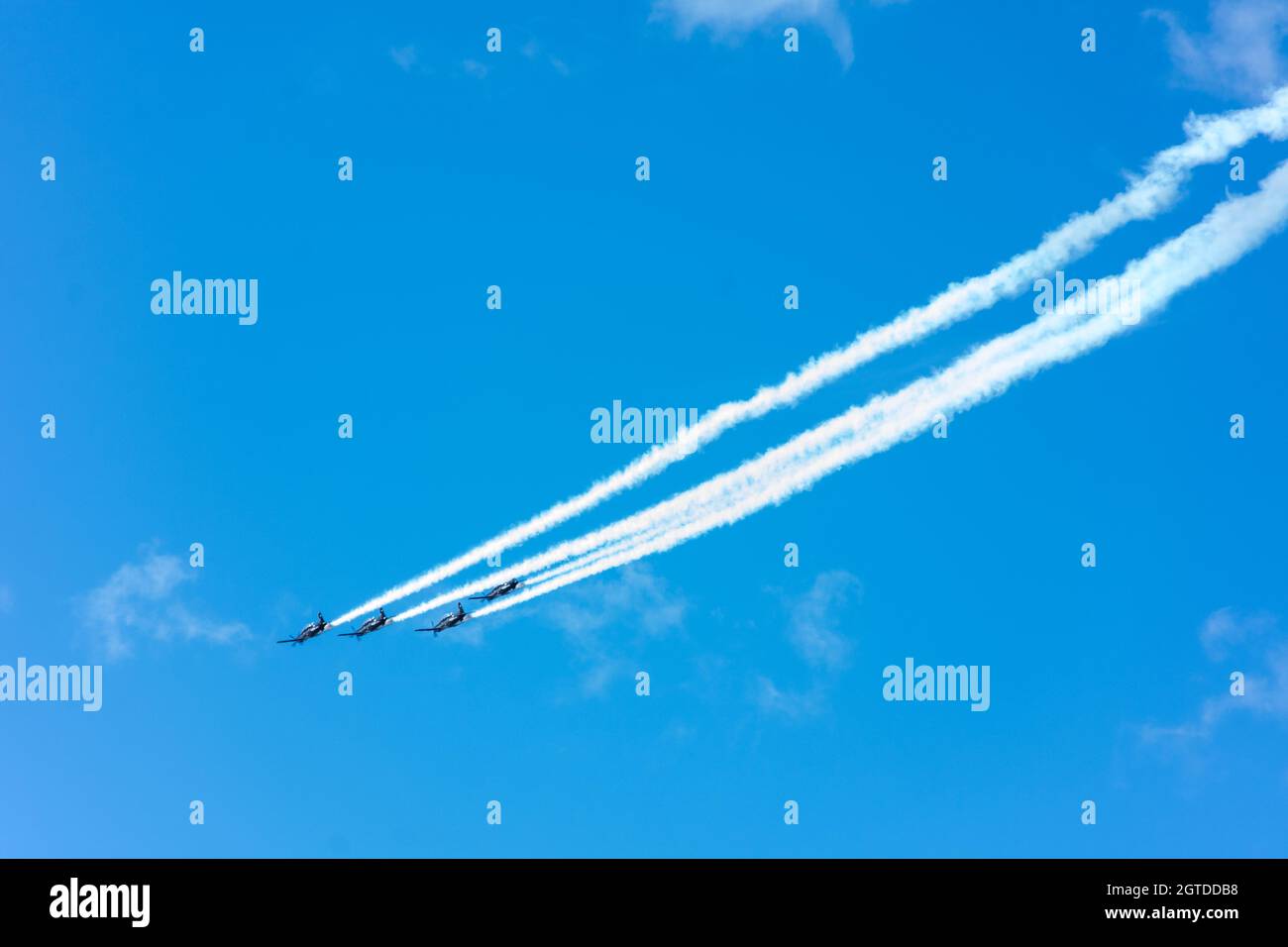 Airplanes flying in formation with smoke trails Stock Photo - Alamy