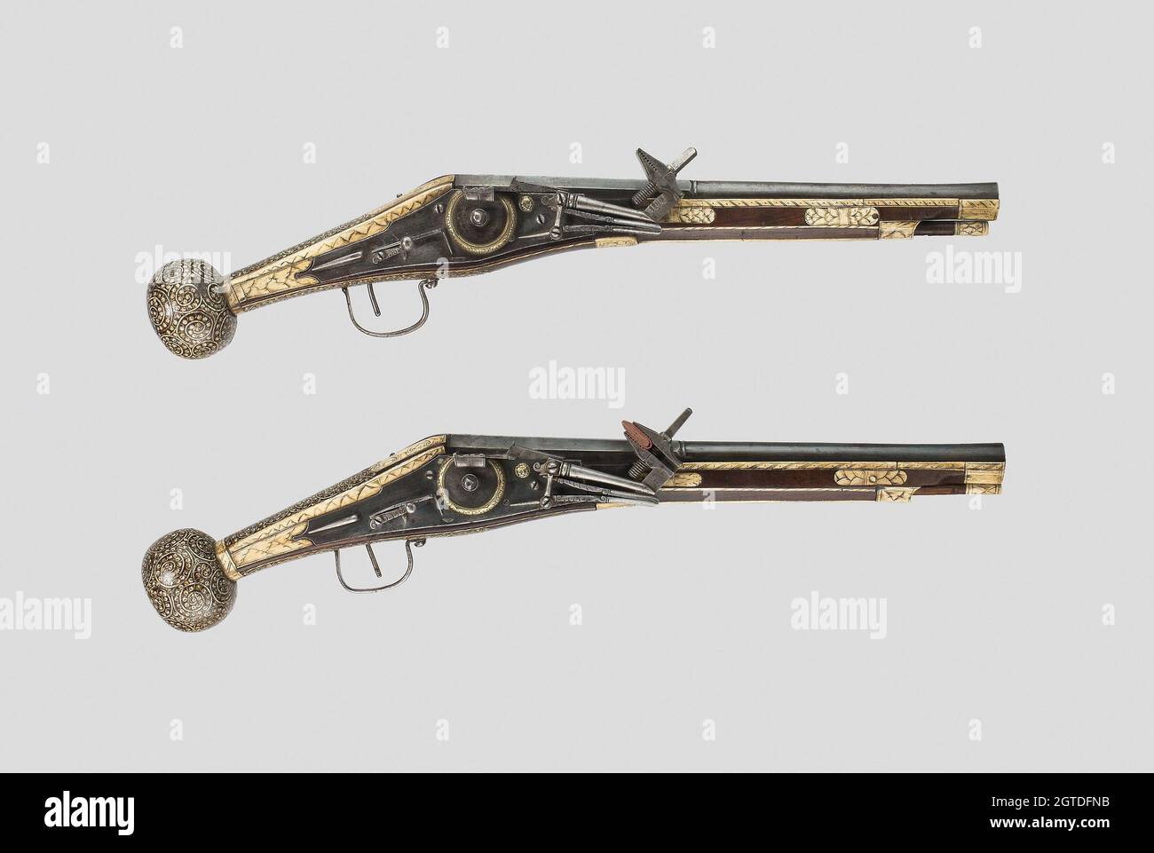 Vertical shot of old metal guns on white background Stock Photo - Alamy