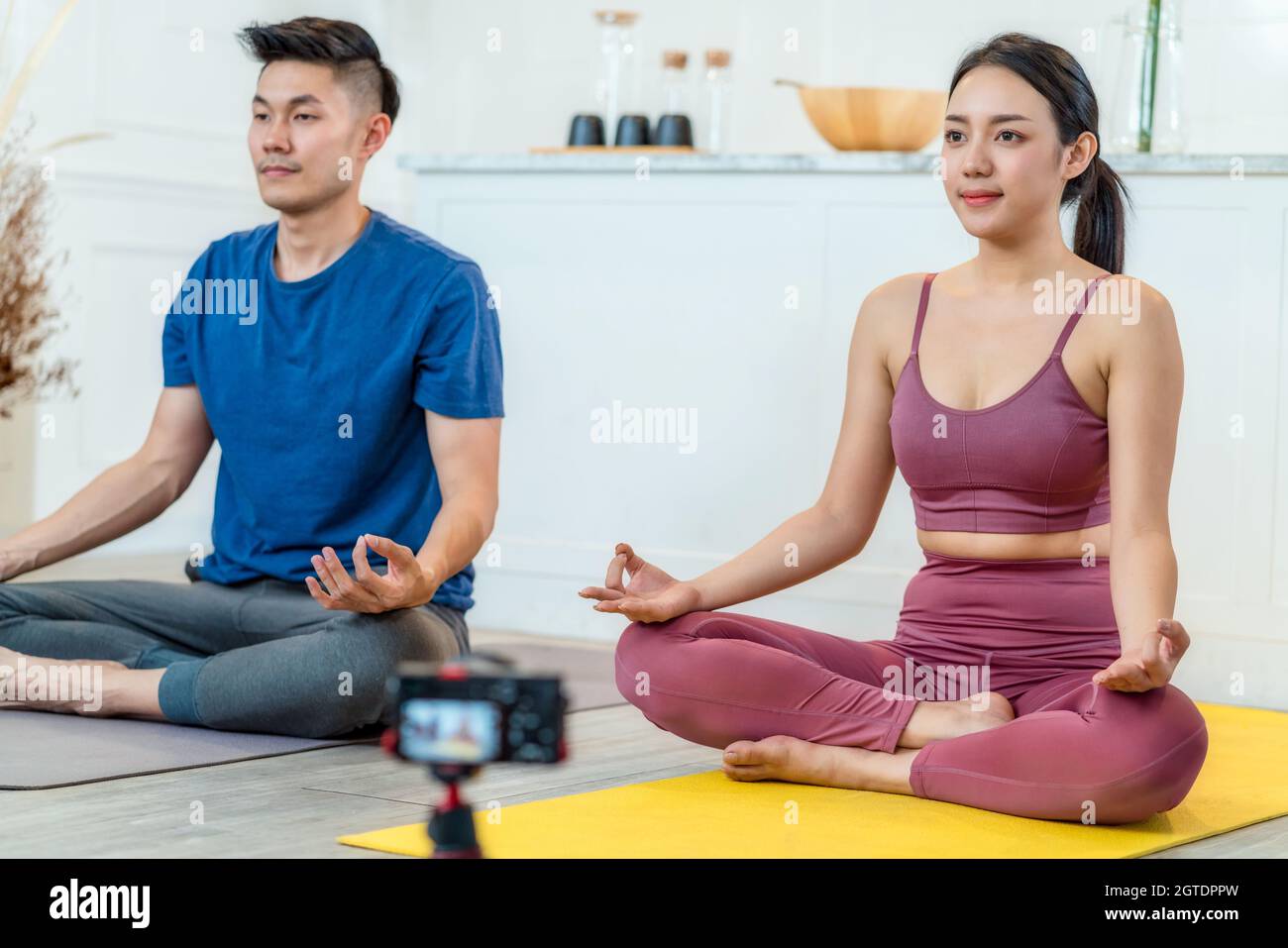 Exercises at home concept, Two Asian couple practicing yoga at home ...