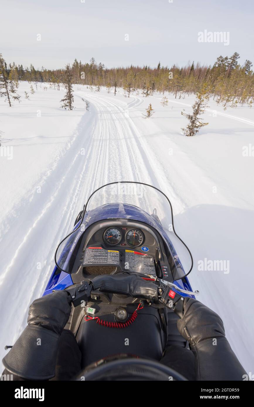 driver on a snowmobile in swedish winter landscape Stock Photo - Alamy