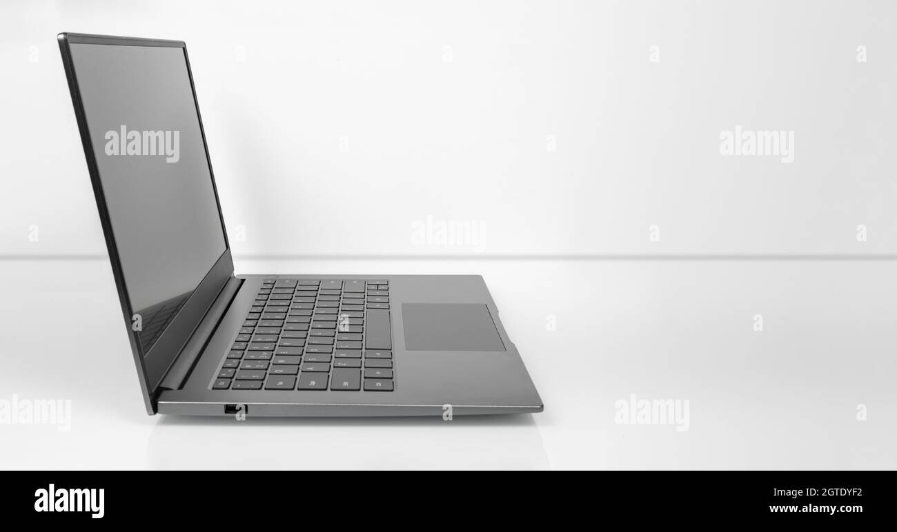 Laptop on a light table. black screen with reflections, gray metal ...