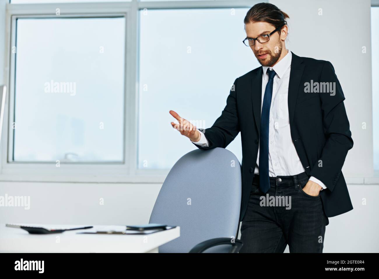 man in a suit near the desktop office computer Lifestyle Stock Photo ...