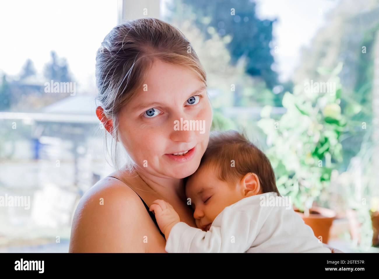 Baby face against window hi-res stock photography and images - Alamy