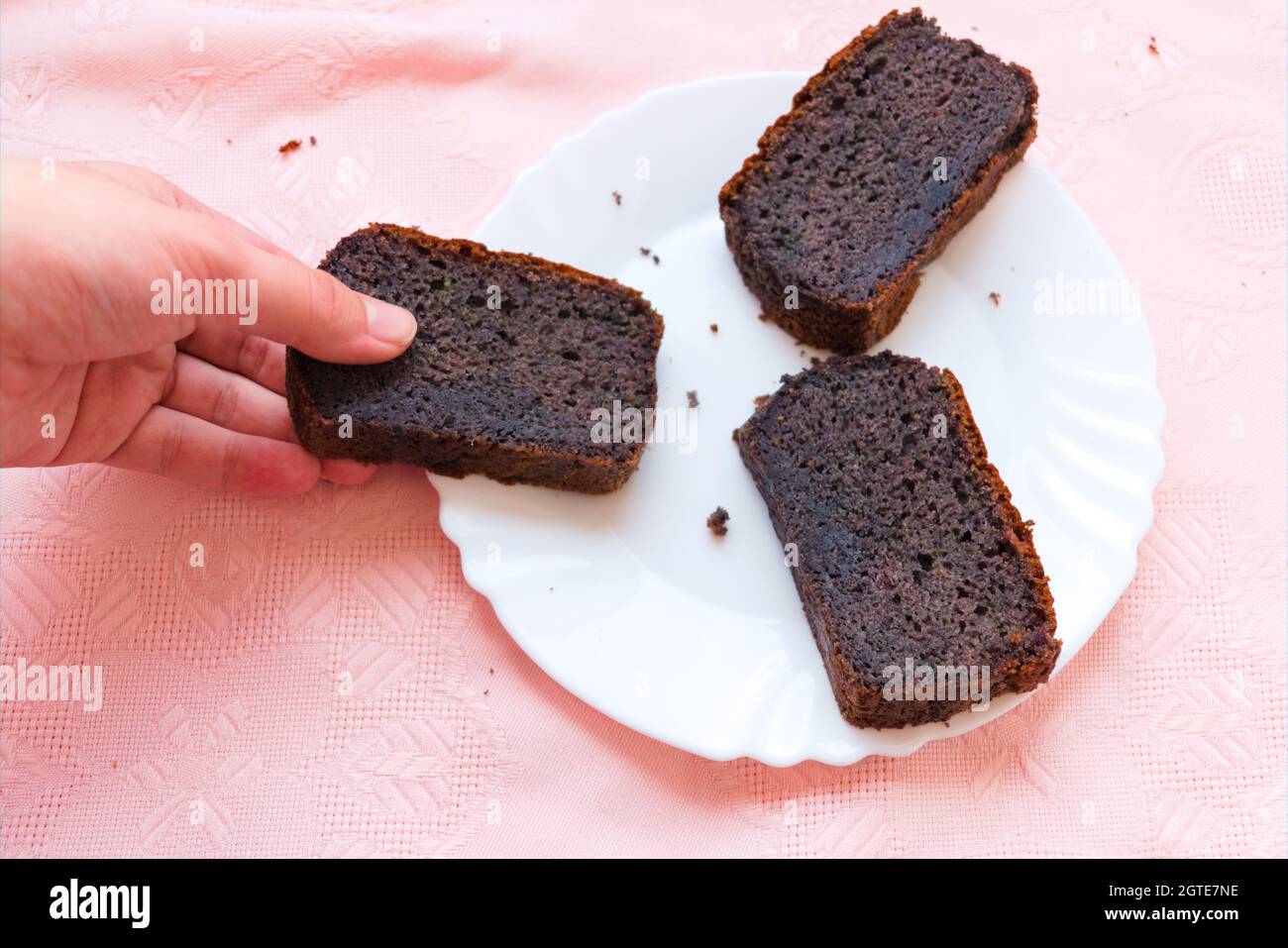 Hand Grabbing A Piece Of Homemade Cake From The Plate, Over A Pink ...