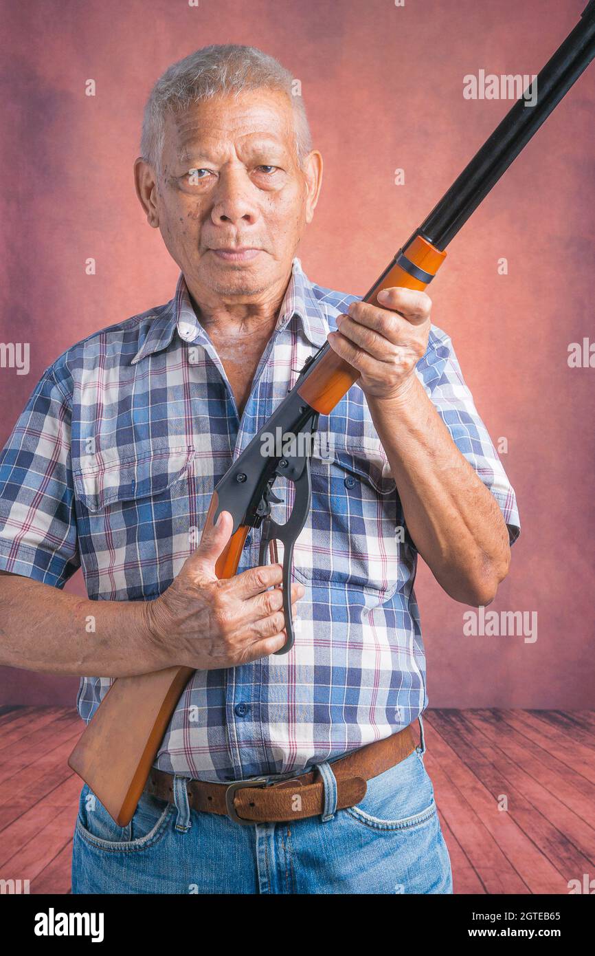 Cowboy holding shotgun hi-res stock photography and images - Alamy