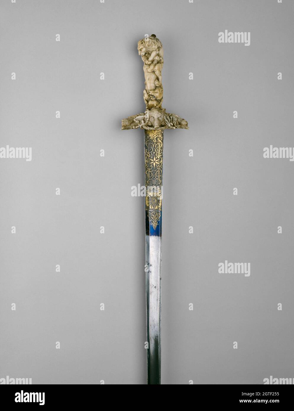 Vertical shot of a pattern sword with a golden handle on white ...