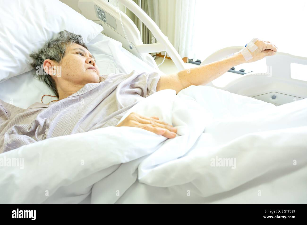 Sad senior women bed hi-res stock photography and images - Alamy