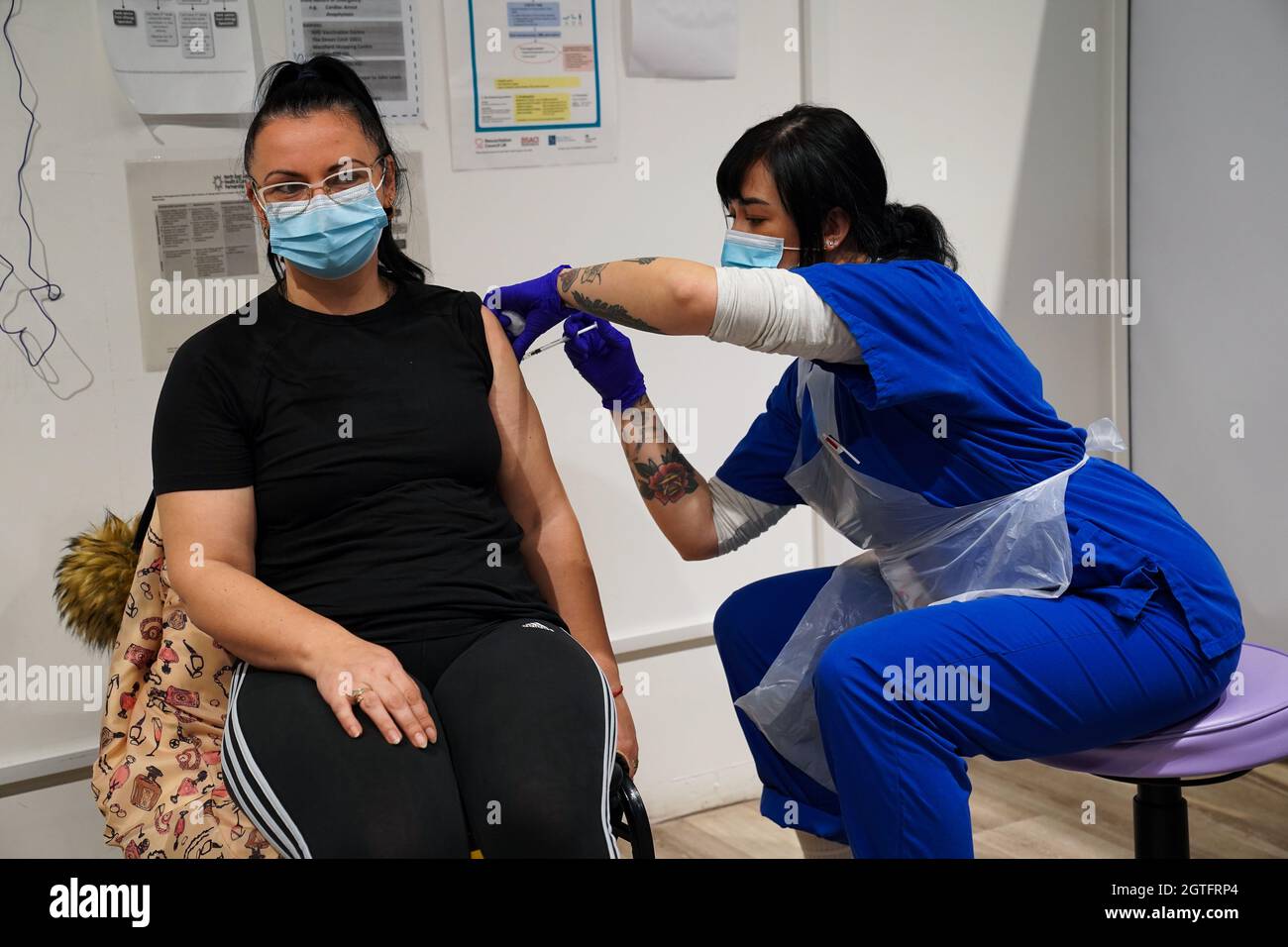 A person receives a Covid-19 Pfizer jab at a pop-up vaccination centre ...