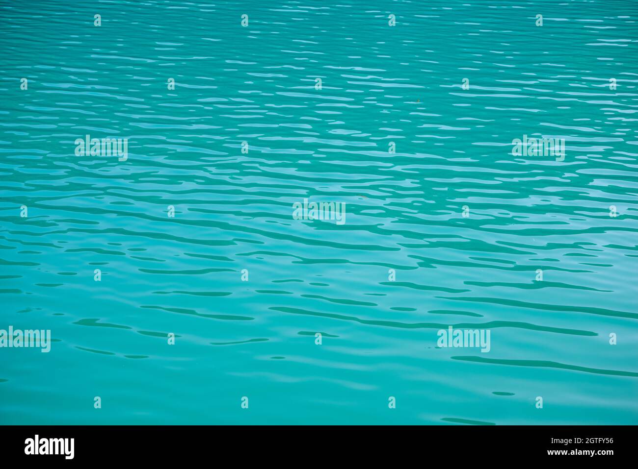 Turquoise water surface with light waves as a texture or background ...
