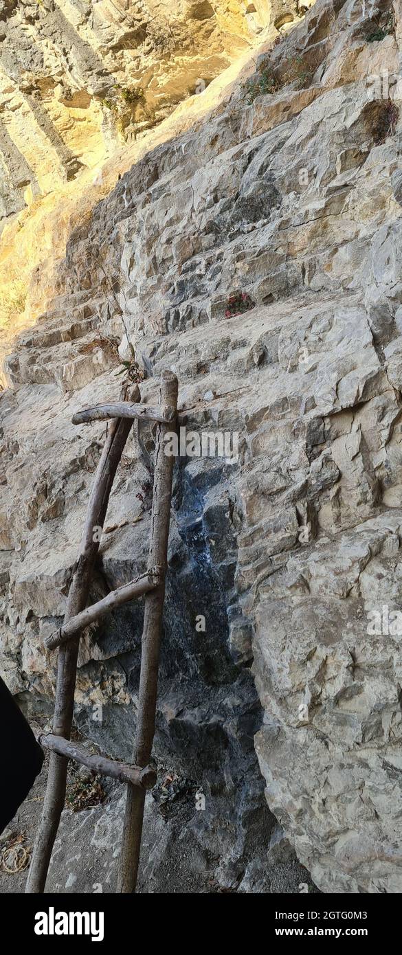 Vertical shot of a broken wooden ladder on a mountain during daylight ...