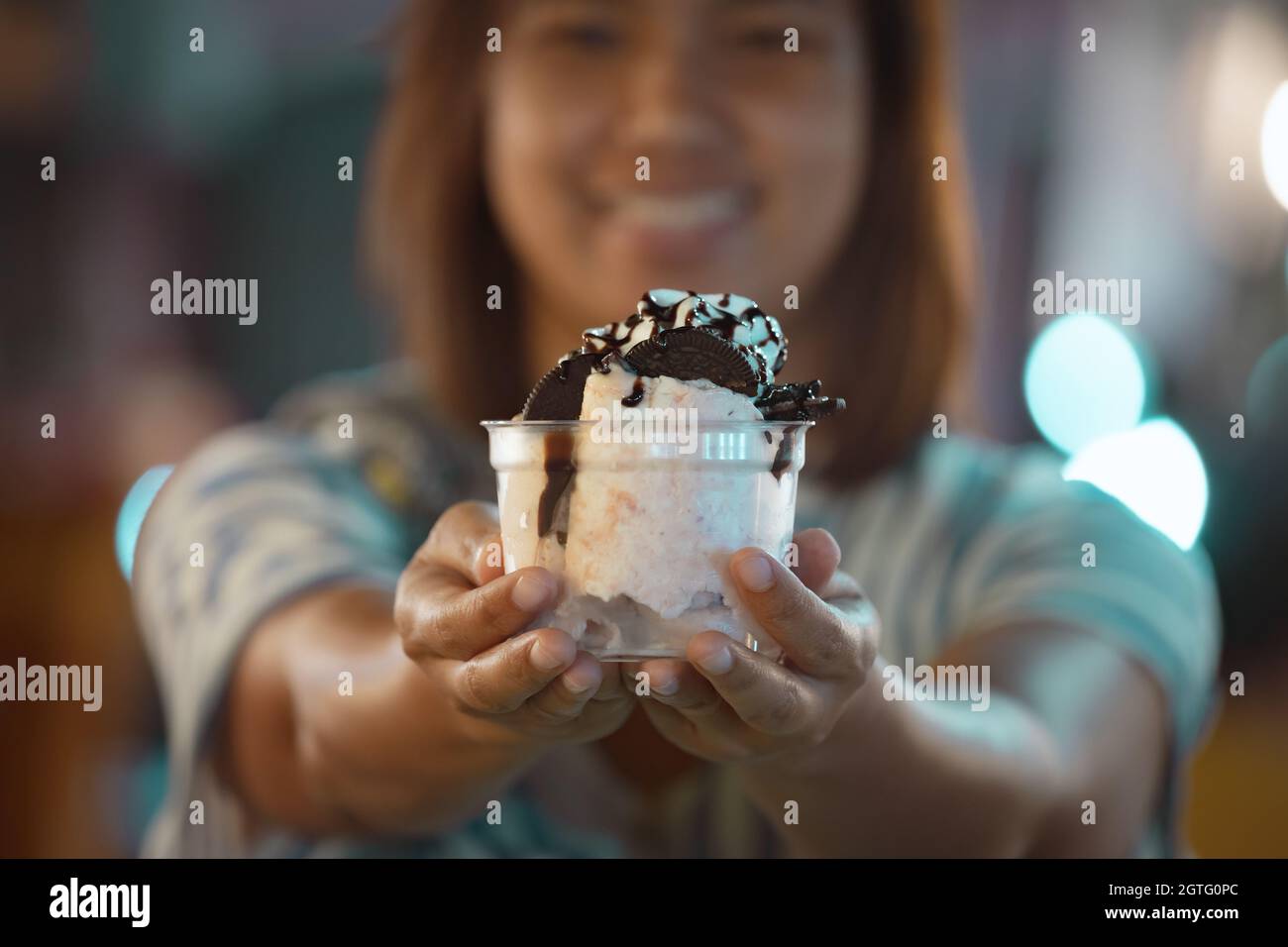Woman giving ice cream hi-res stock photography and images - Alamy
