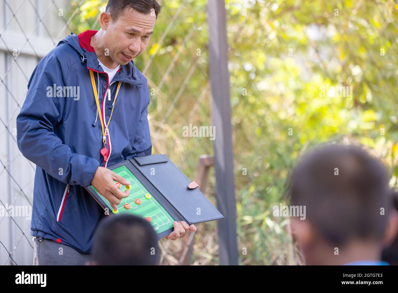 Soccer coach teaching young player hi-res stock photography and images ...