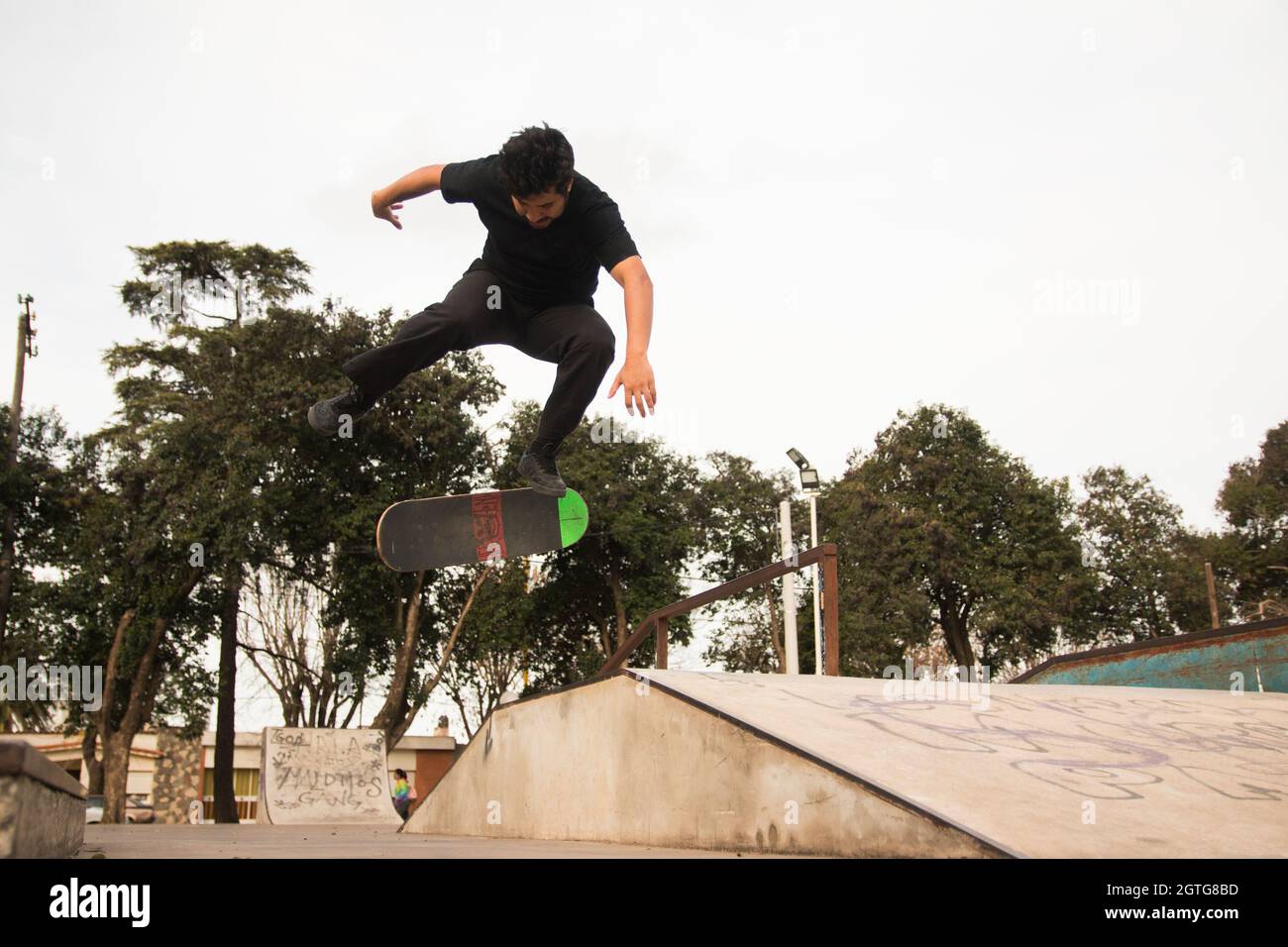 Skateboarder Trick In Skate Park Stock Photo - Alamy