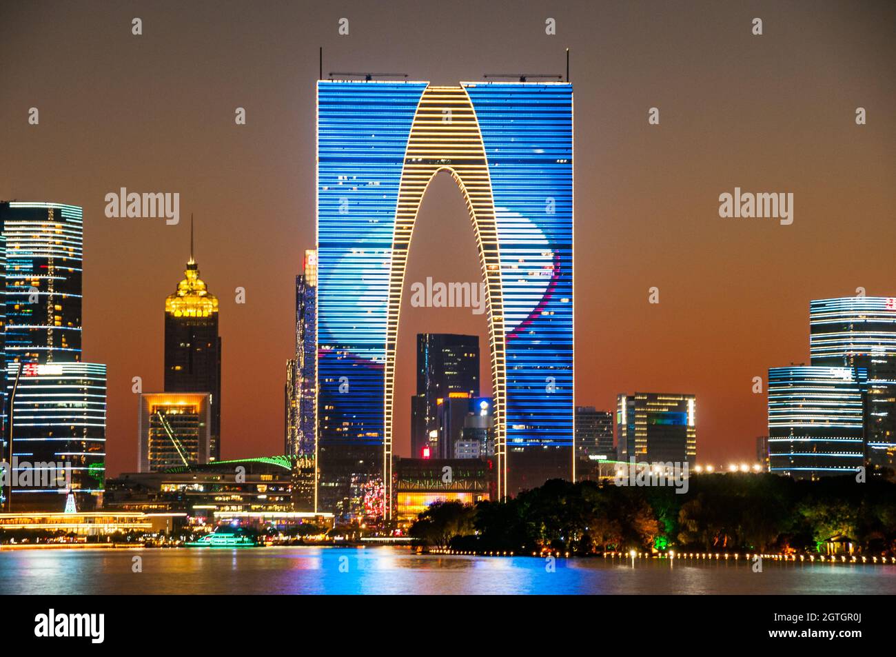 Suzhou’s Gate of the Orient building lit up at night in Jiangsu ...