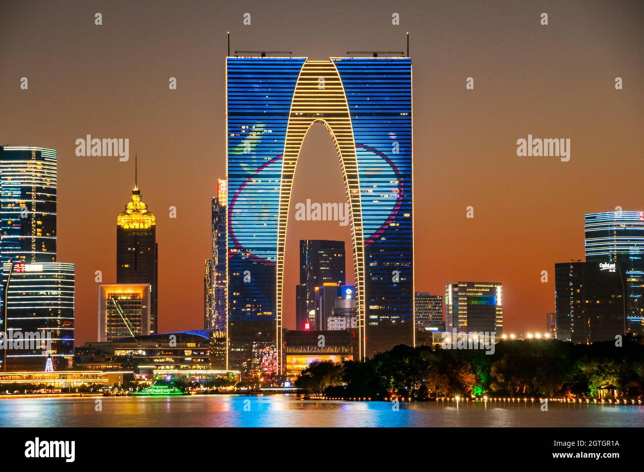 Suzhou’s Gate of the Orient building lit up at night in Jiangsu ...