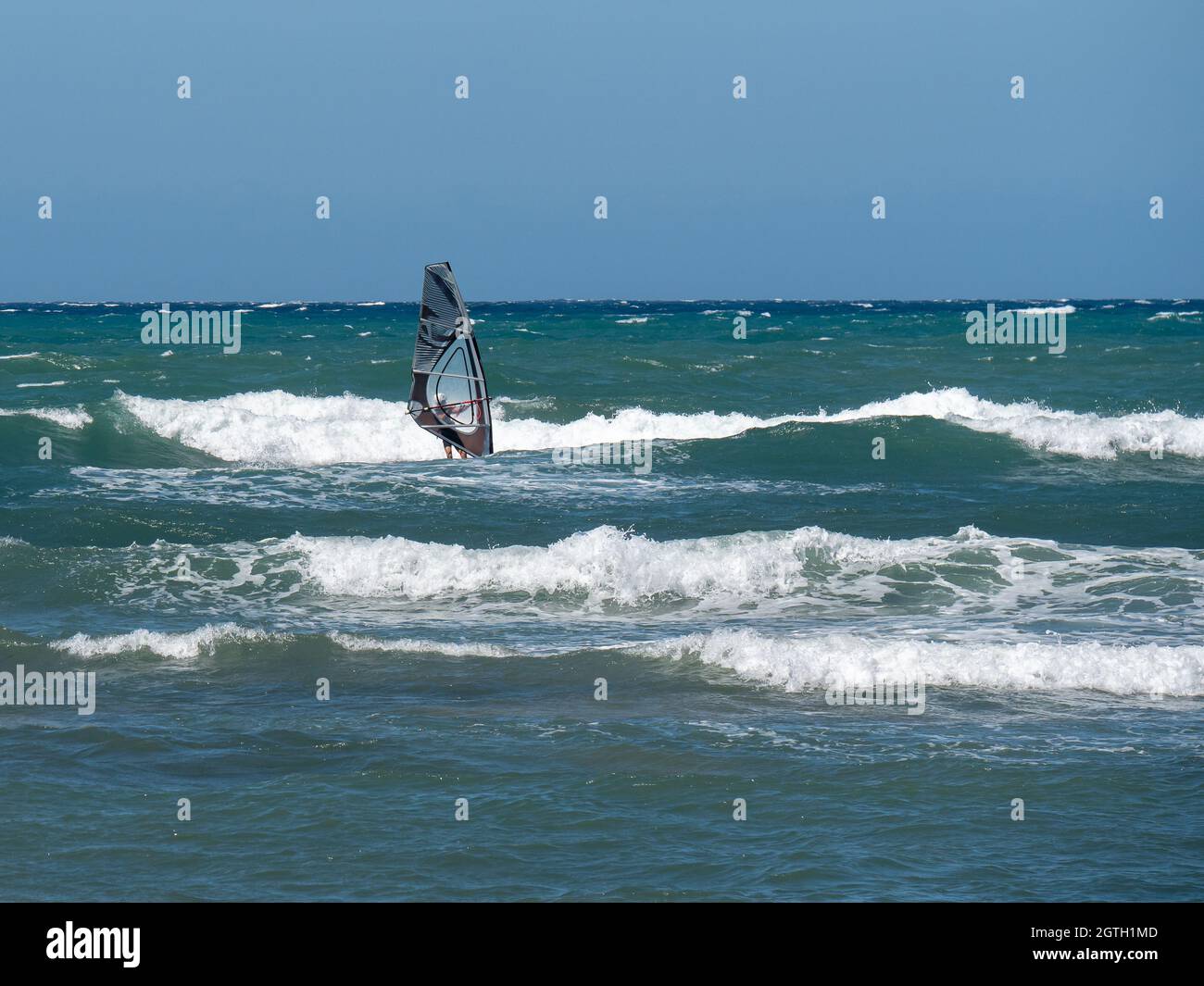 Windsurf Riding the Waves in a Choppy Sea Stock Photo - Alamy