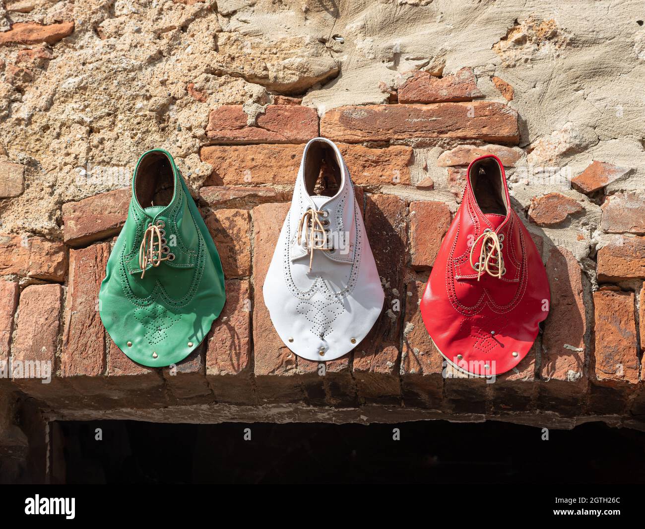 Leather Shape of Red White and Green Shoes Hanging on the Wall Outside ...