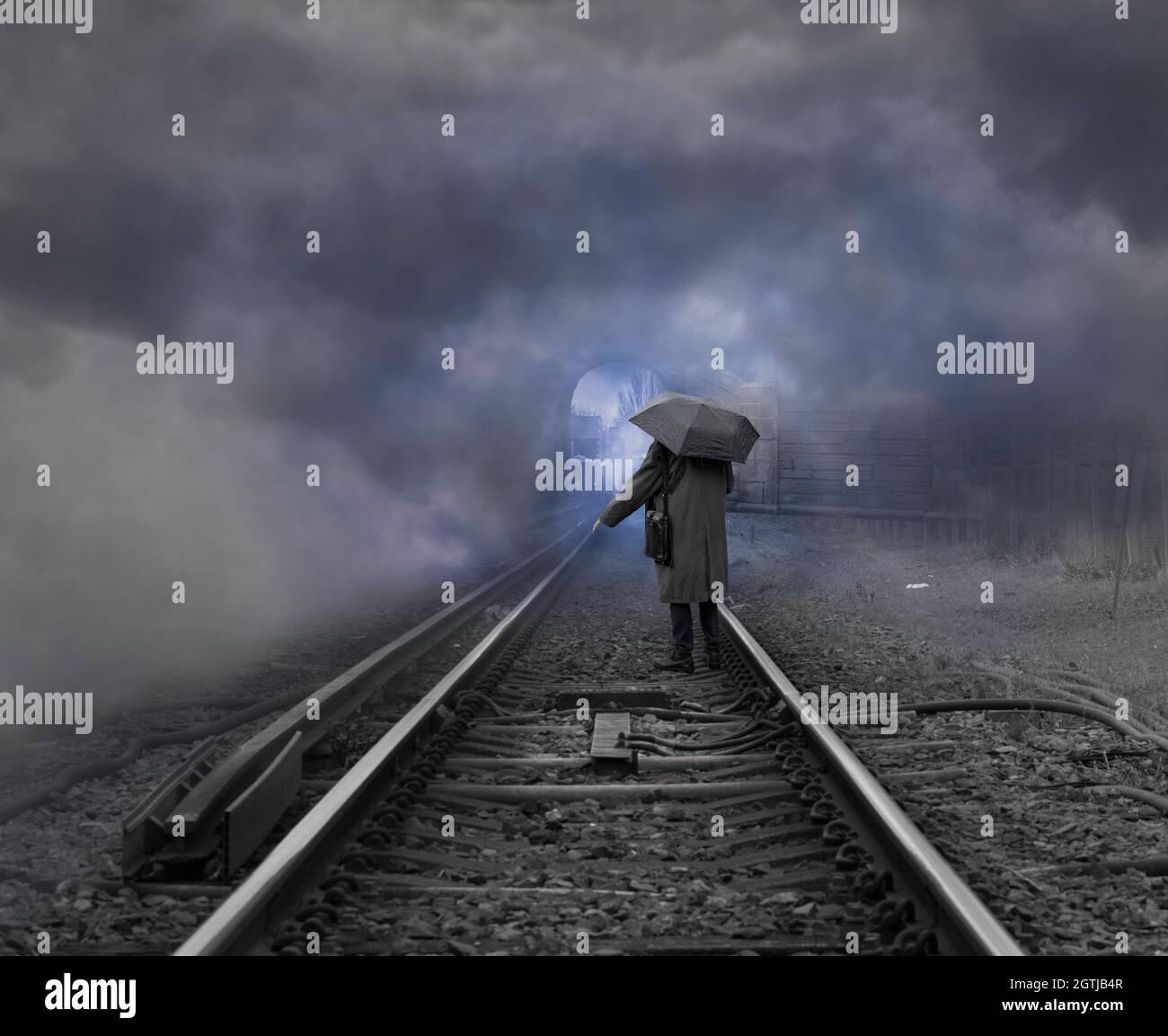 Man going along train line Stock Photo - Alamy