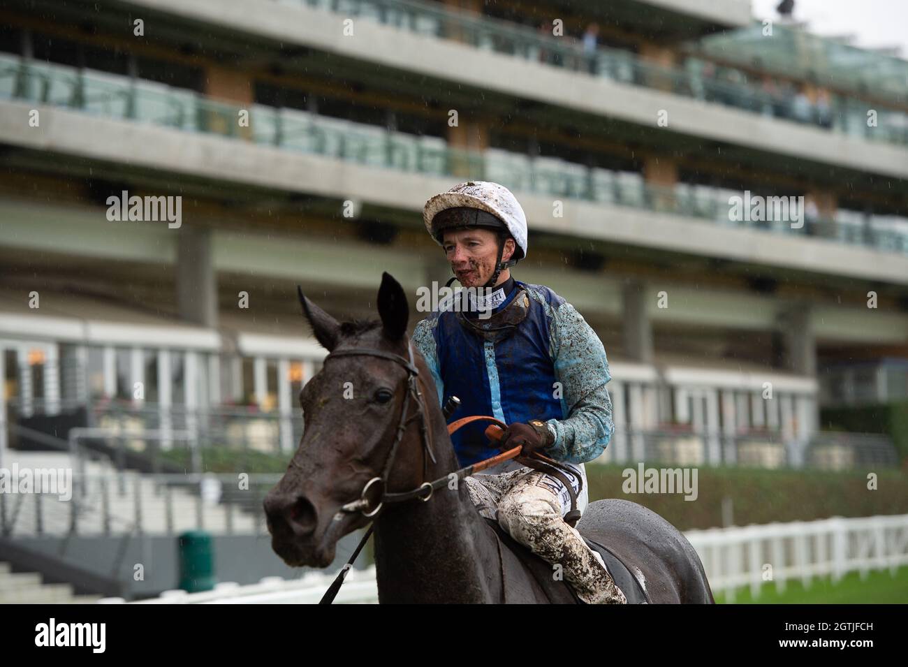 Ascot, UK. 2nd October, 2021. A muddy looking jockey David Allan after ...