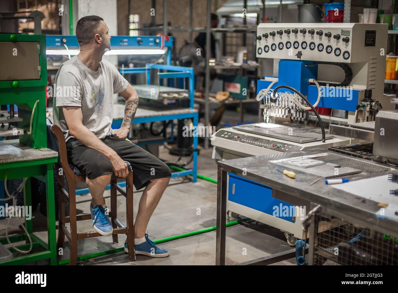 Professional worker technician machinist work in factory production ...