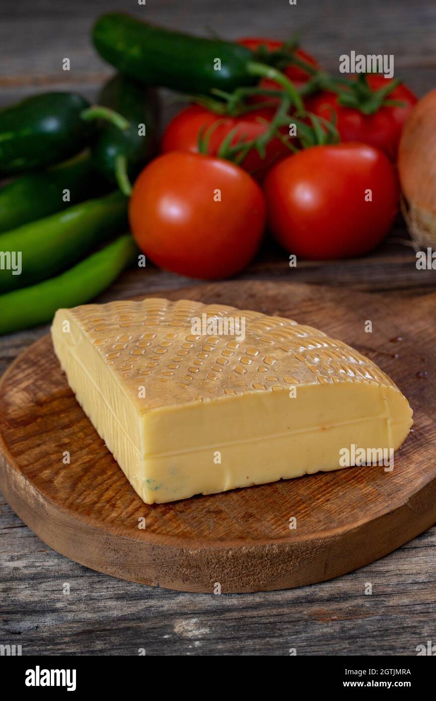 Smoked cheese on wood background Stock Photo - Alamy