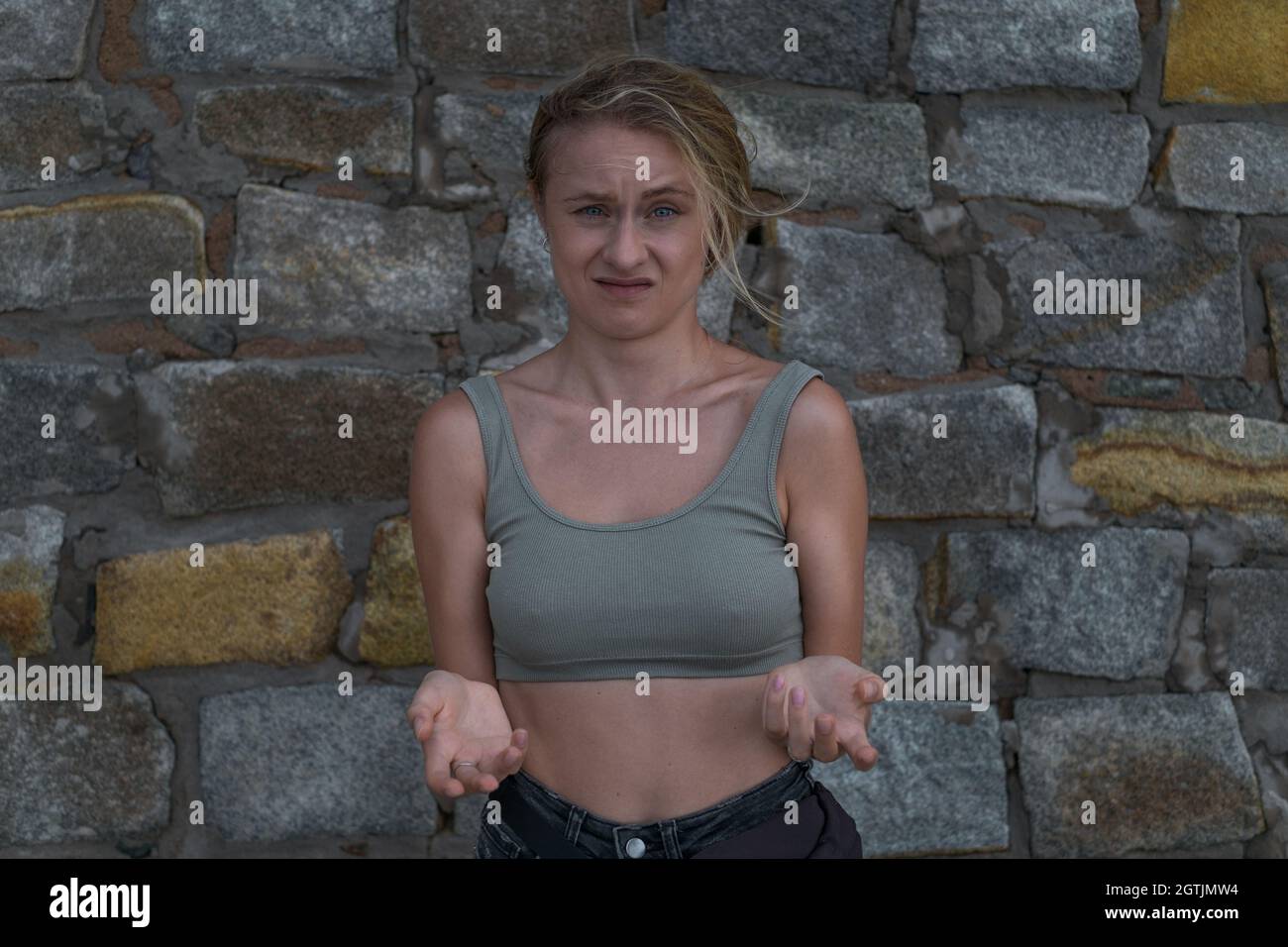 Misunderstood surprised face of young caucasian woman in crop top on ...