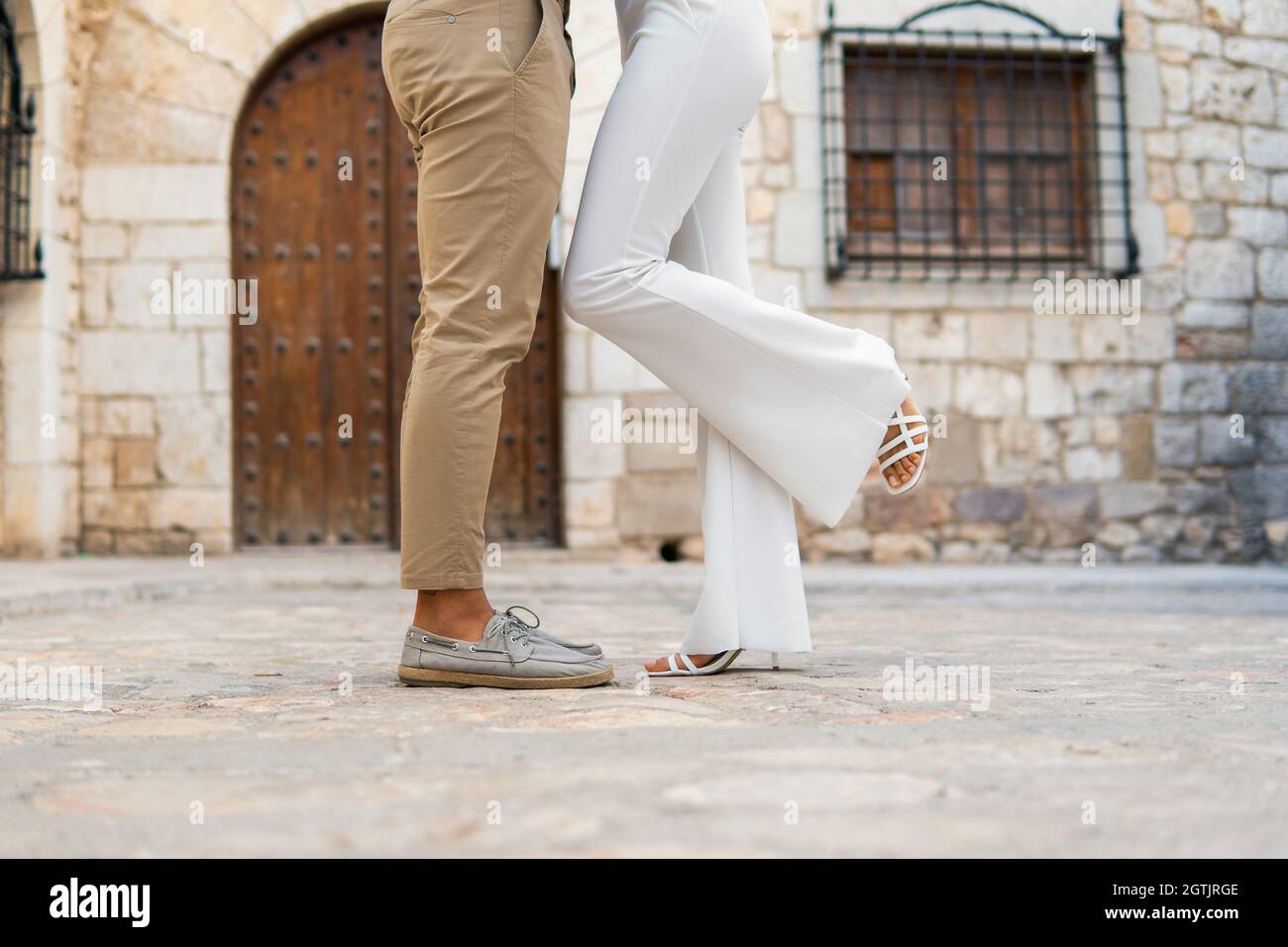 Side view of crop anonymous stylish boyfriend and girlfriend standing ...