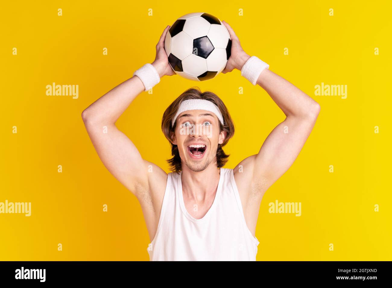 Portrait of handsome cheerful guy throwing soccer ball match time ...