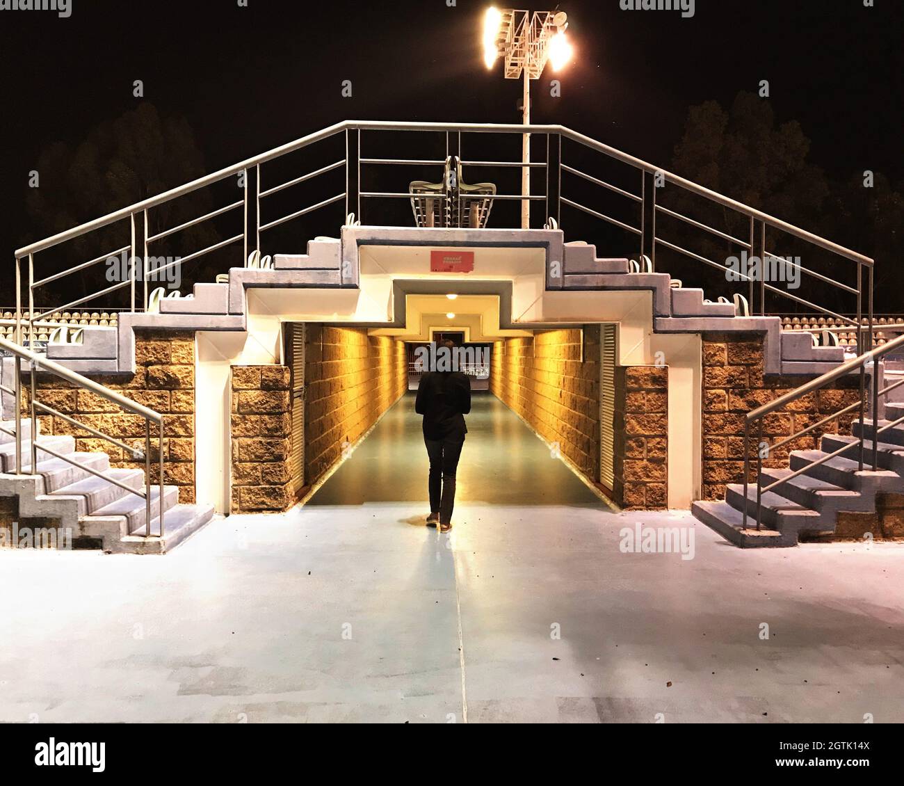 Woman walking towards light tunnel hi-res stock photography and images ...
