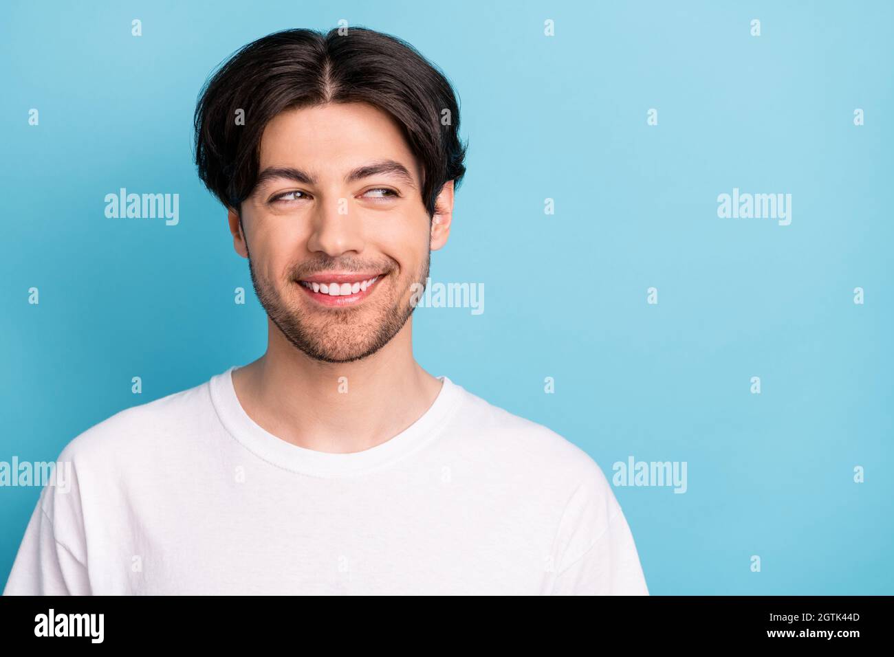 Photo of nice young brunet guy look empty space wear white t-shirt ...