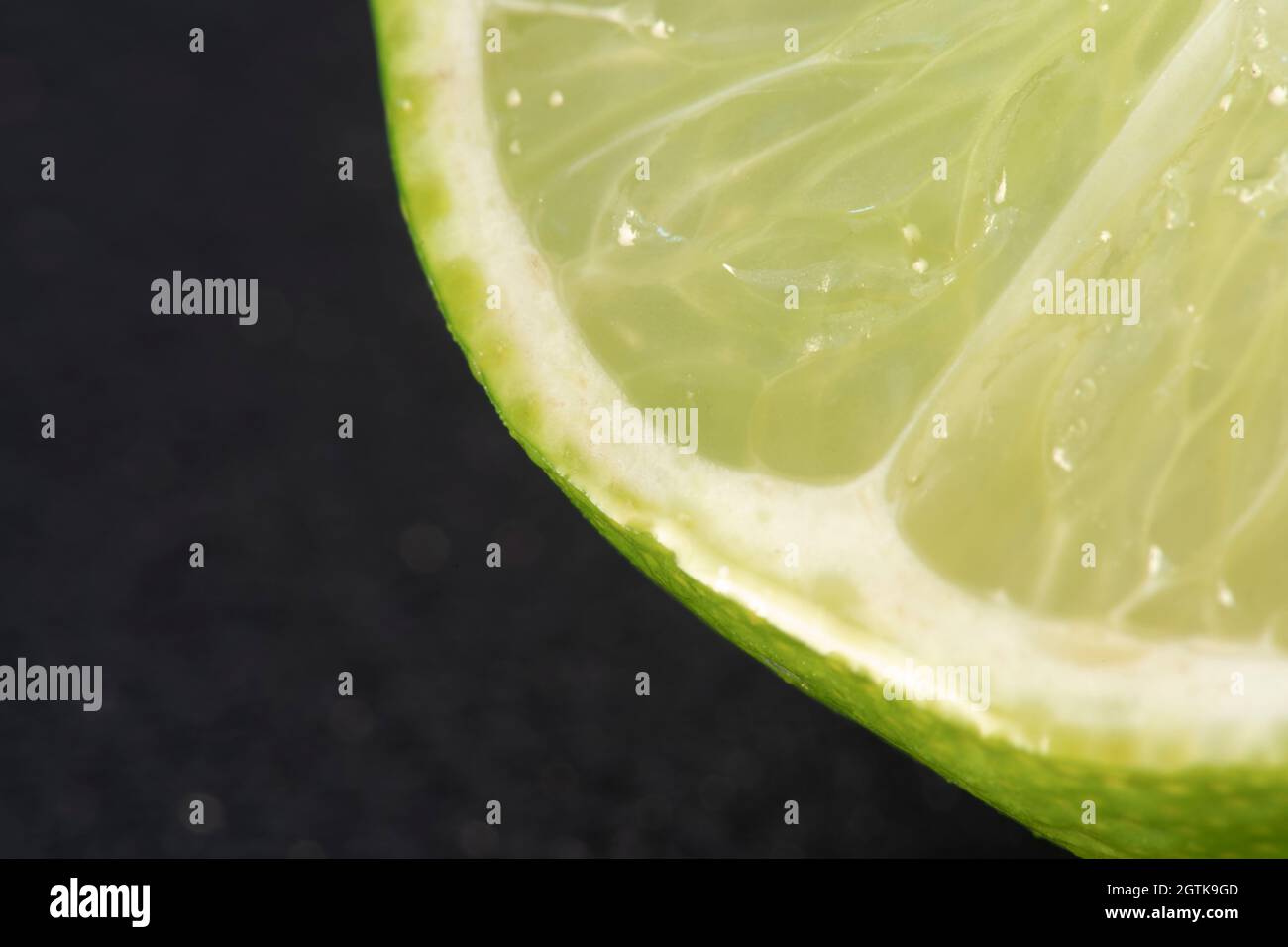 Macro fruit: Ripe lime slice extreme close-up with black background ...