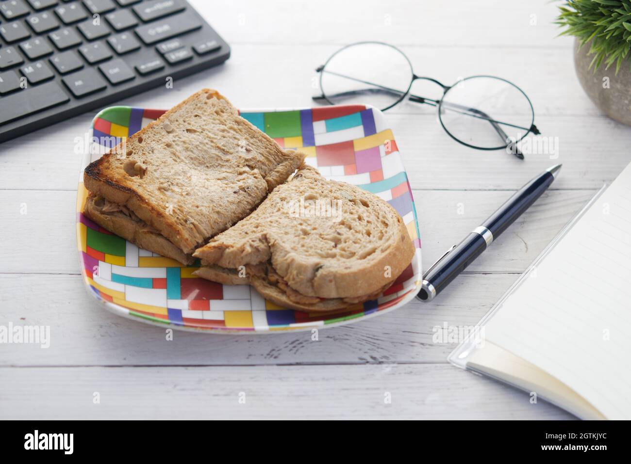 hand pick vegetable sandwich on a pate on office table Stock Photo - Alamy