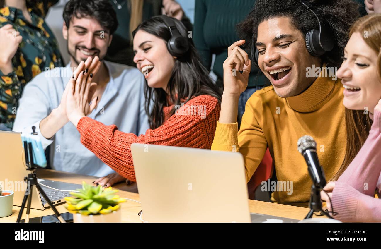 Young people recording a podcast using microphone and laptop from home ...