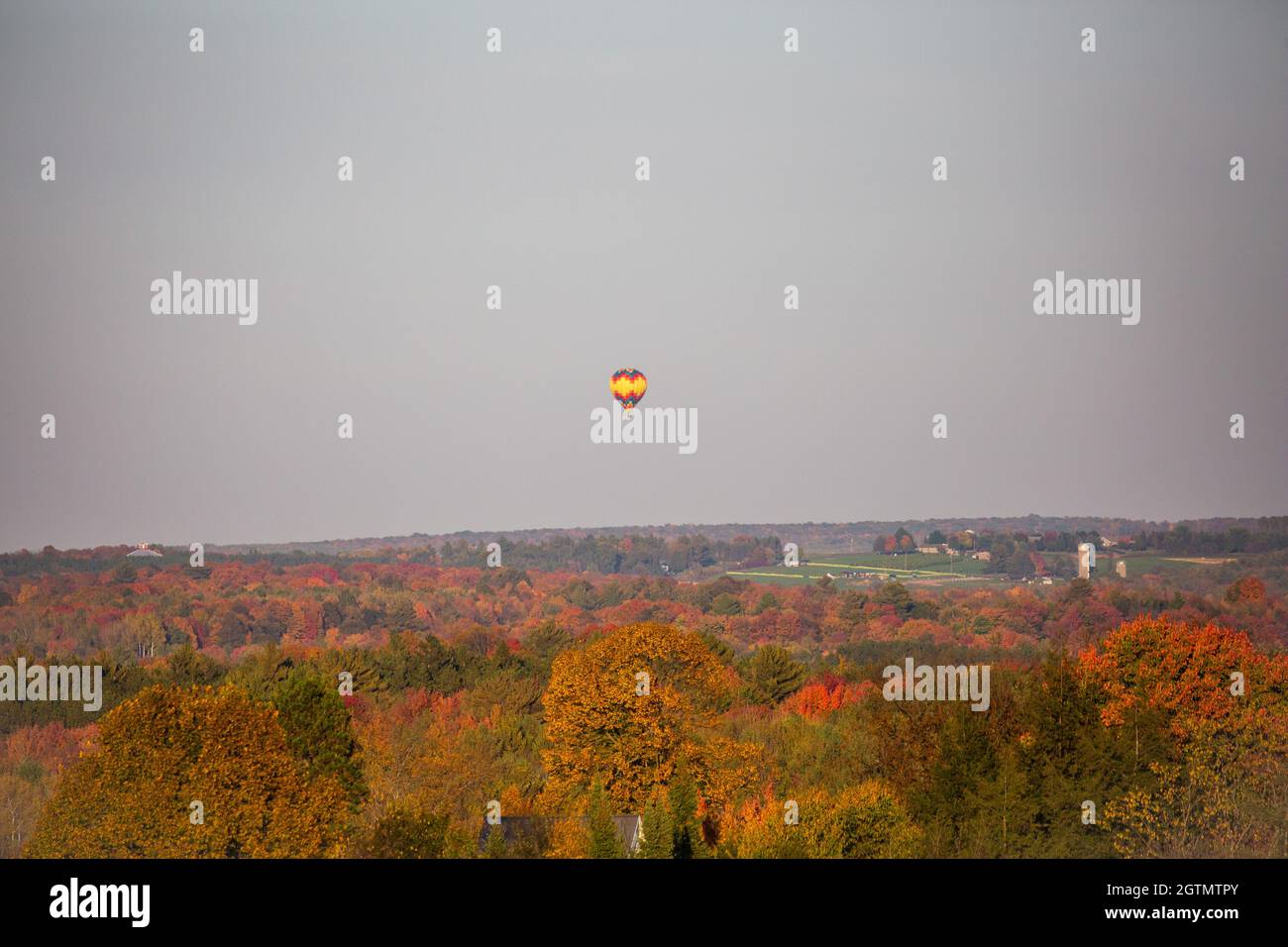 Hot air balloon flying over Wisconsin farmland in late September ...