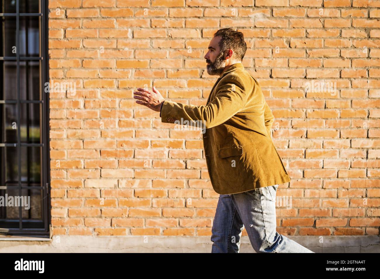 Modern businessman with beard running in a hurry on the street Stock ...