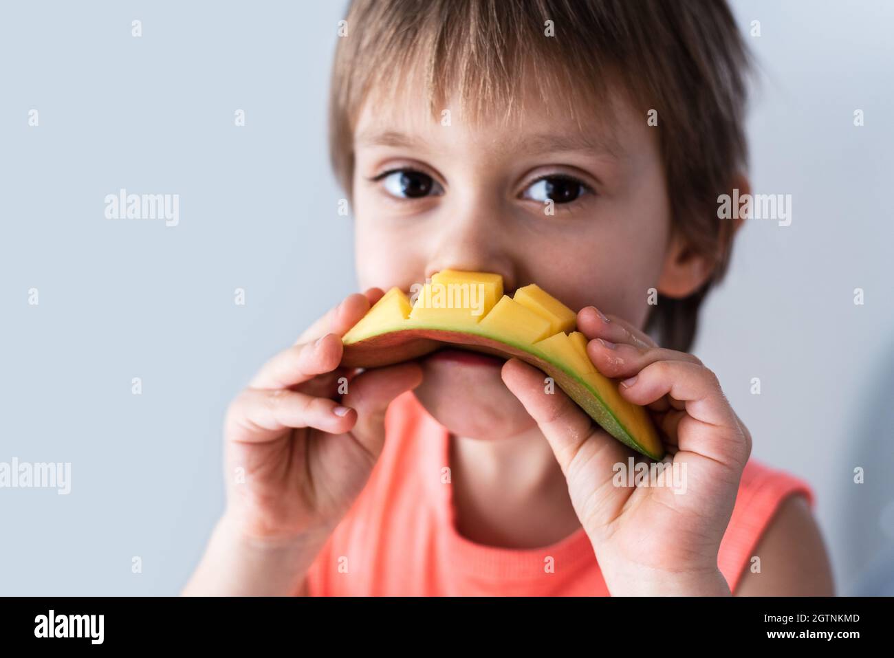 Boy eating mango hi-res stock photography and images - Alamy