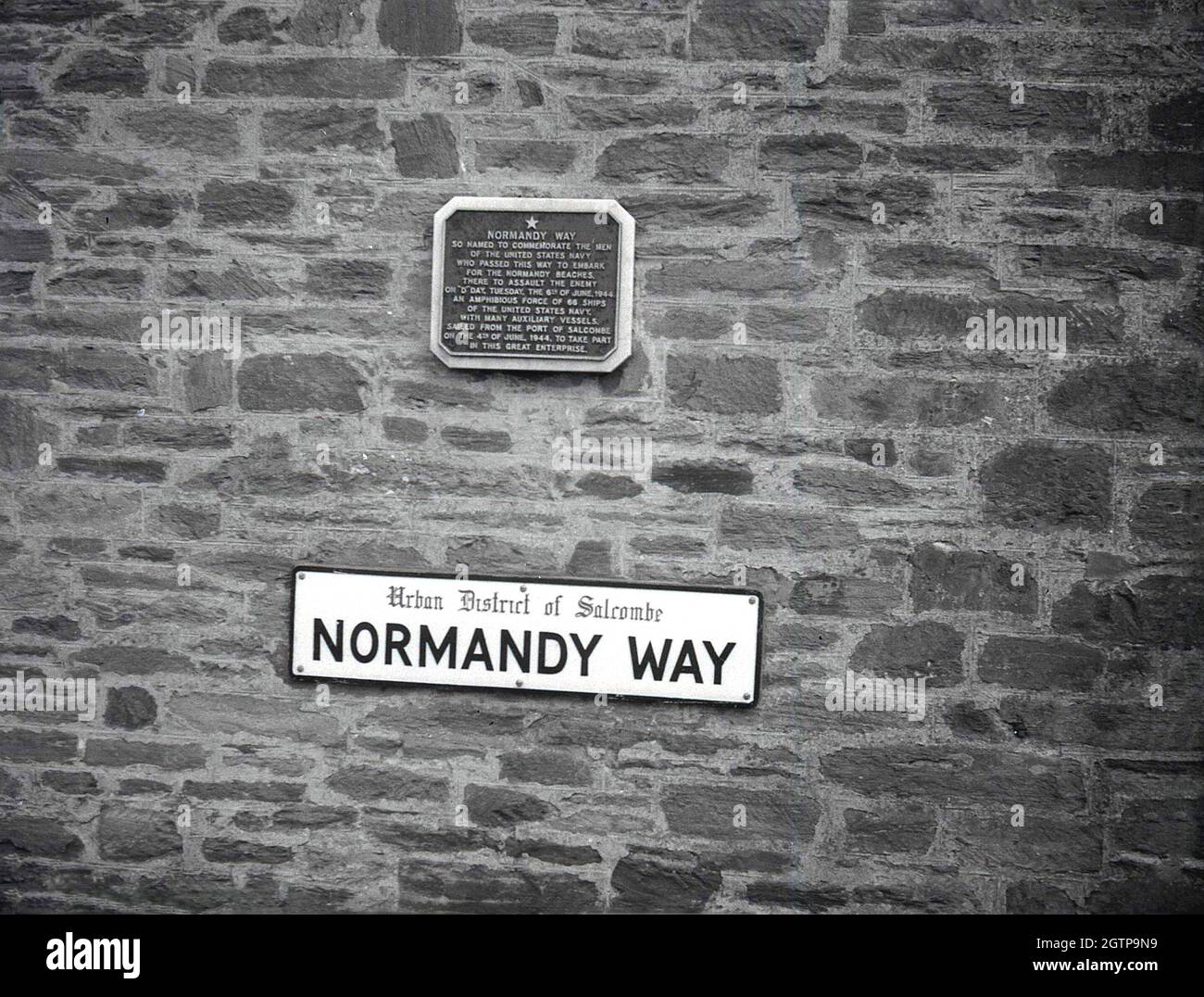 1950s, historical, a street sign on a stone wall, Normandy Way ...
