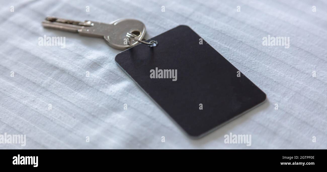 Door key with blank label. Steel key ring, room key and empty black tag ...