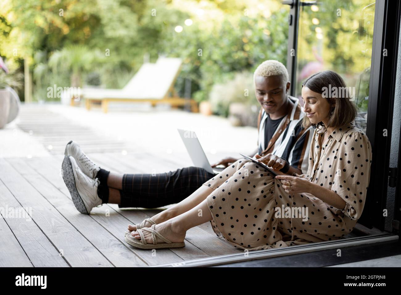 Man watching something on girl`s digital tablet Stock Photo - Alamy