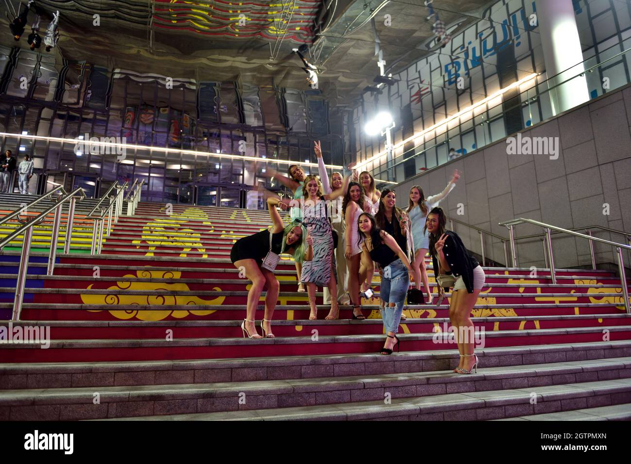 Group of young women out celebrating on a Saturday night, on steps of ...