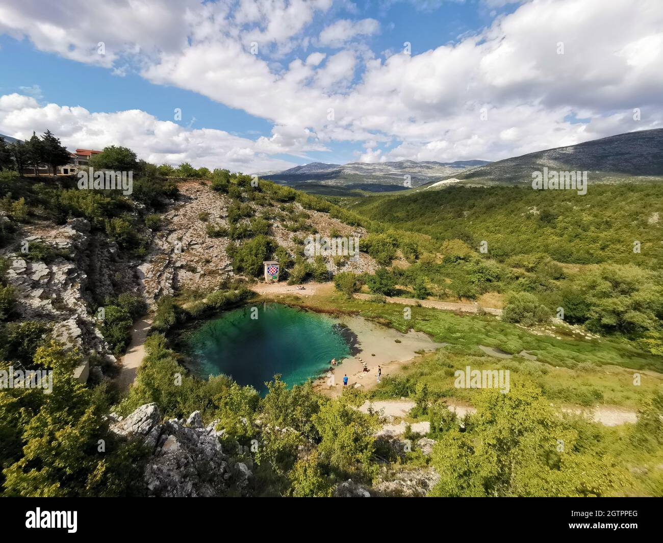 Azure pond in a green mountainous area Stock Photo - Alamy
