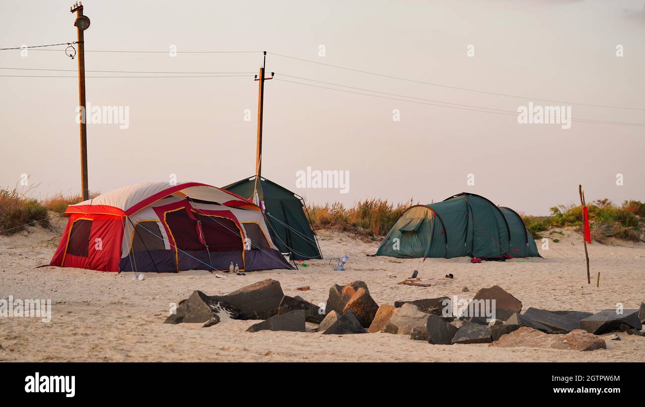 Tent camping on the sandy beach in the evening, morning sun, lifestyle ...