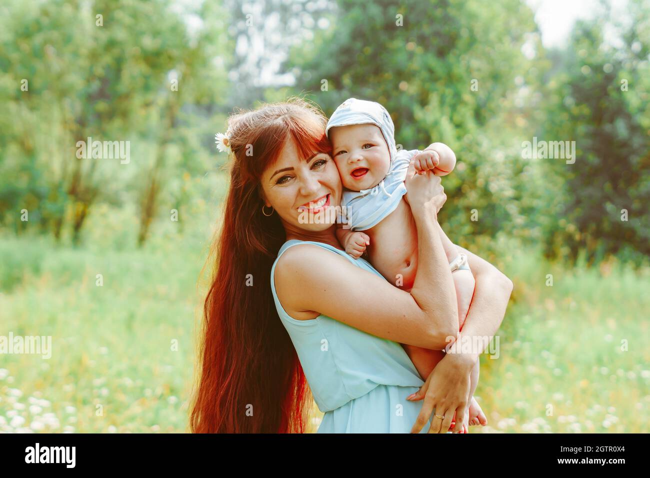 mother raises the child in her arms Stock Photo - Alamy