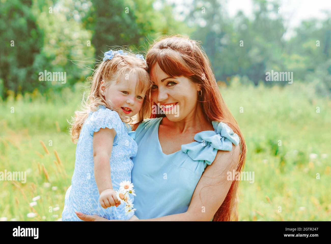 mom hugs her daughter in nature Stock Photo - Alamy