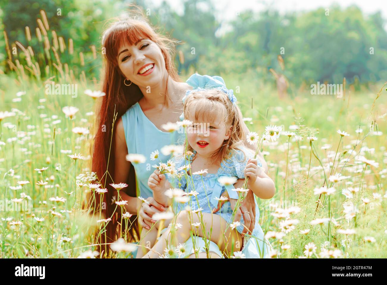 mom hugs her daughter in nature Stock Photo - Alamy
